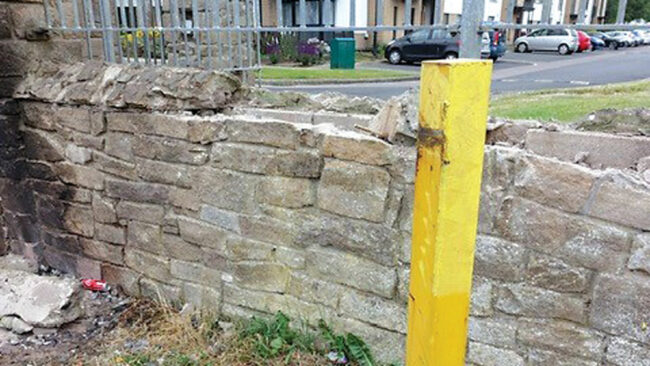 Deterioration of stone wall beside apartments causing ‘havoc’ and ...